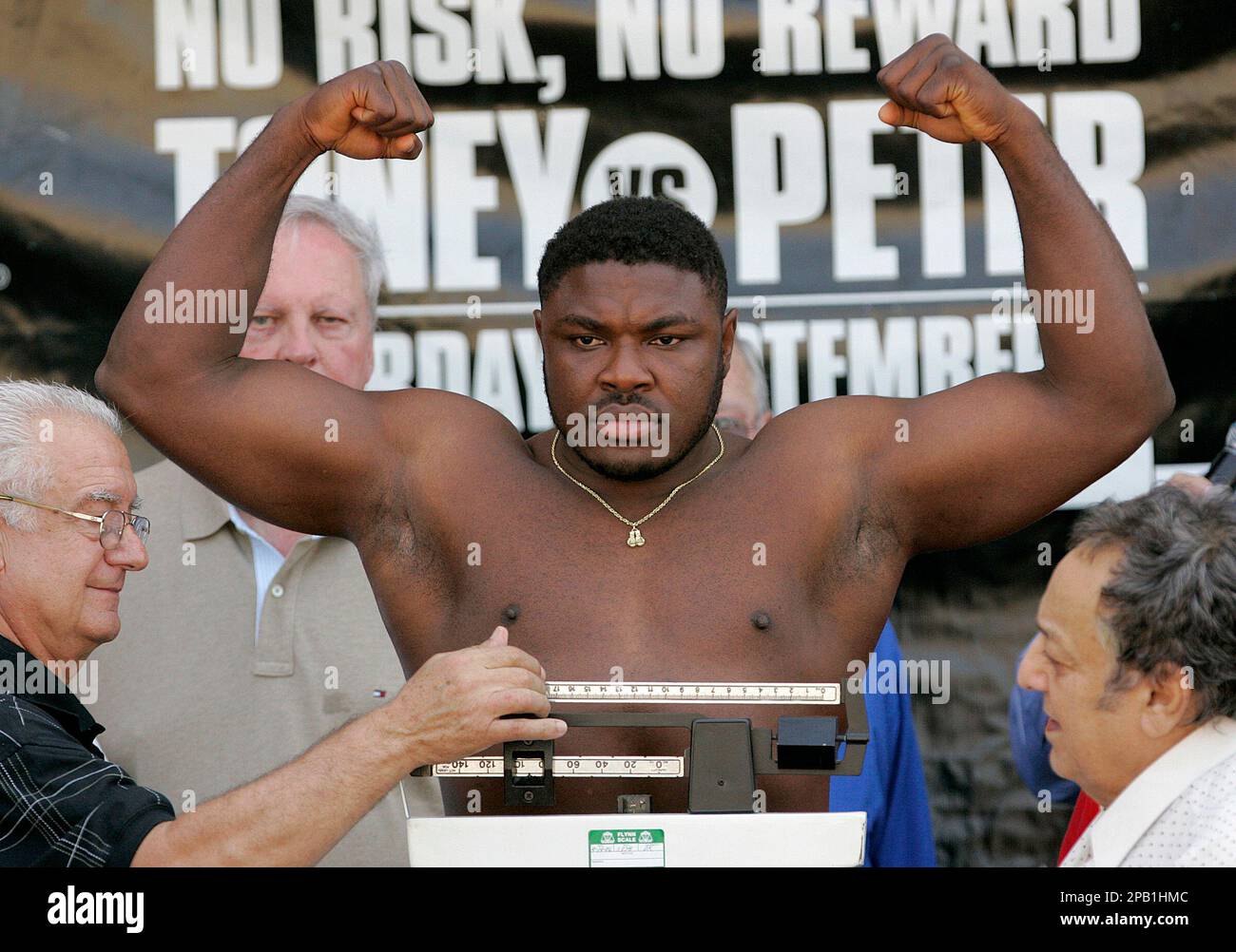 ** FILE ** Boxer Samuel Peter flexes on the scale during the official ...