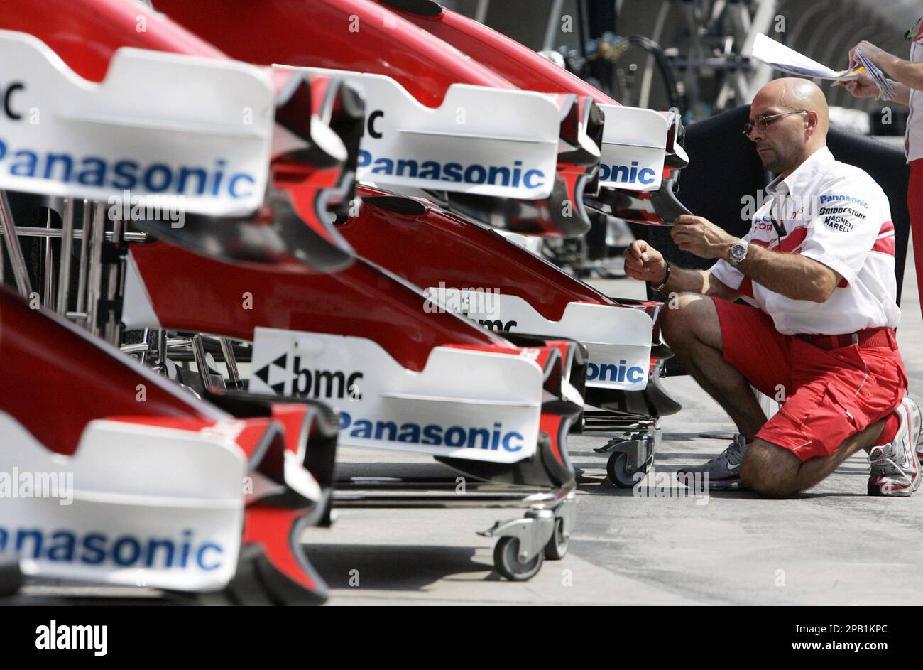 Parts of Toyota F1 machines are checked by mechanics at the team's ...