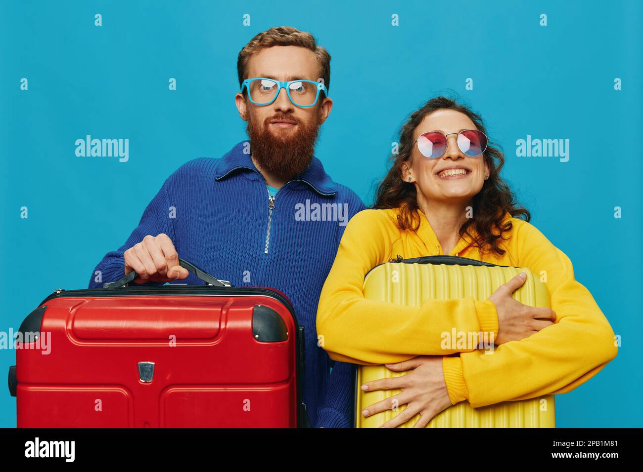 Woman and man smile suitcases in hand with yellow and red suitcase ...