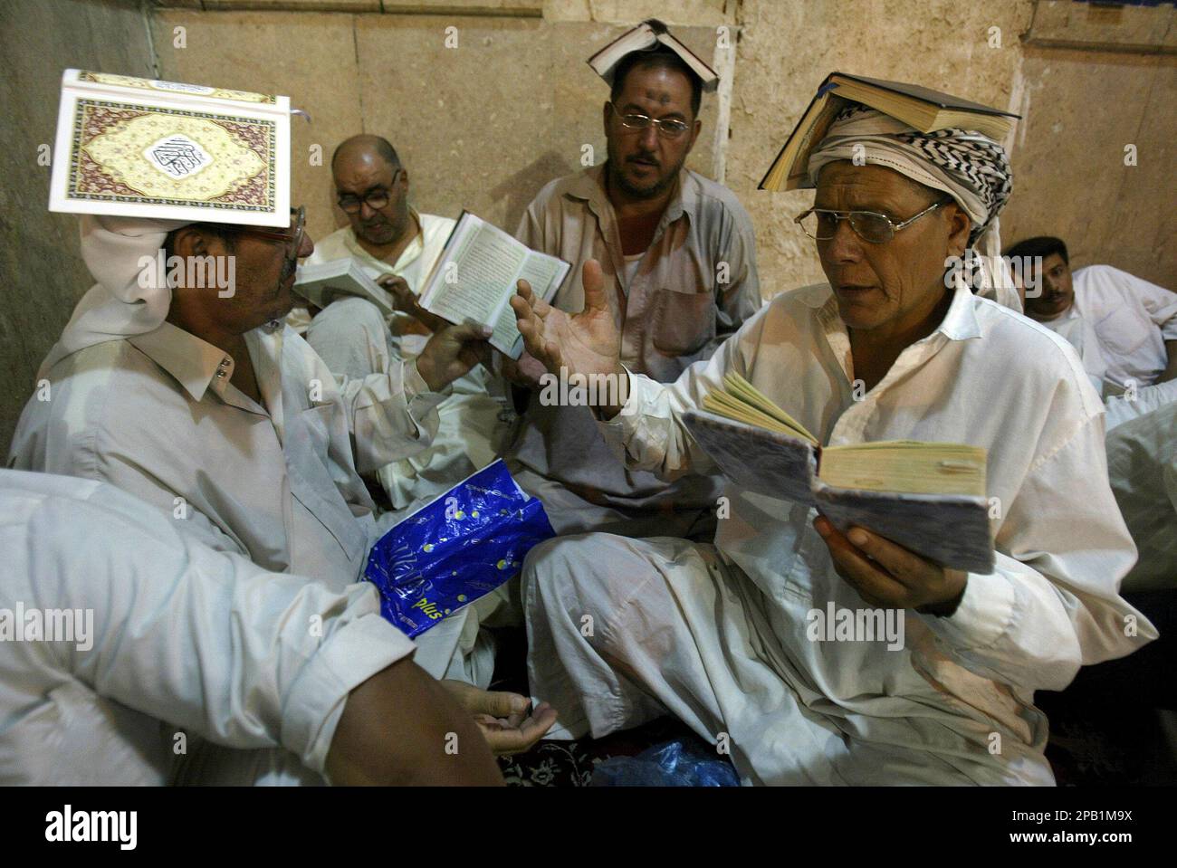 With the Quran on their heads Iraqi Shiite Muslims pray on the death ...