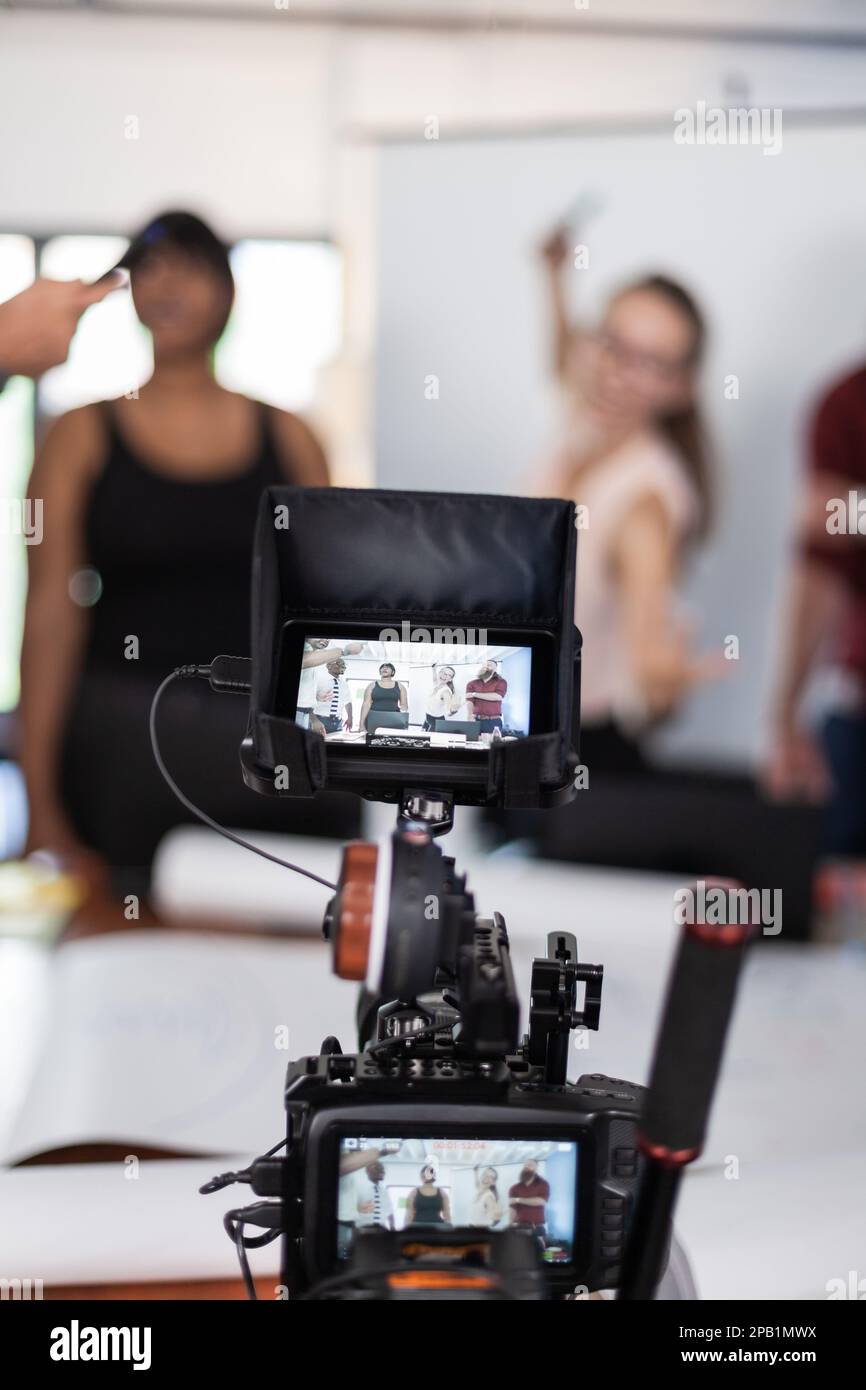 Professional camera recording multiracial business people having ...