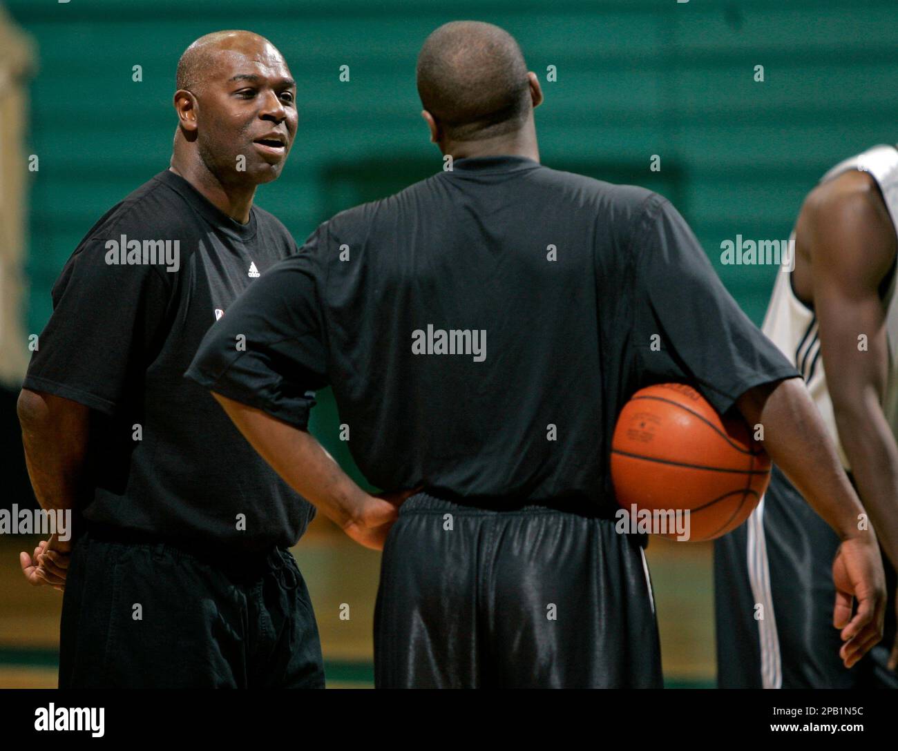 Charlotte Bobcats assistant coach Phil Ford, left, talks with Raymond ...
