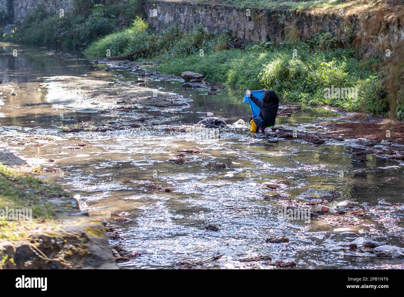 Zapopan, Jalisco Mexico. January 1, 2023. Stream with a homeless person ...