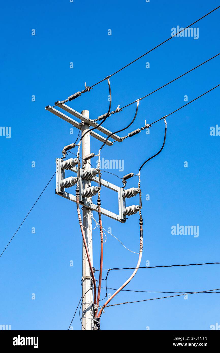 Top of a high voltage power pole, electrical wires, sunny day with a ...