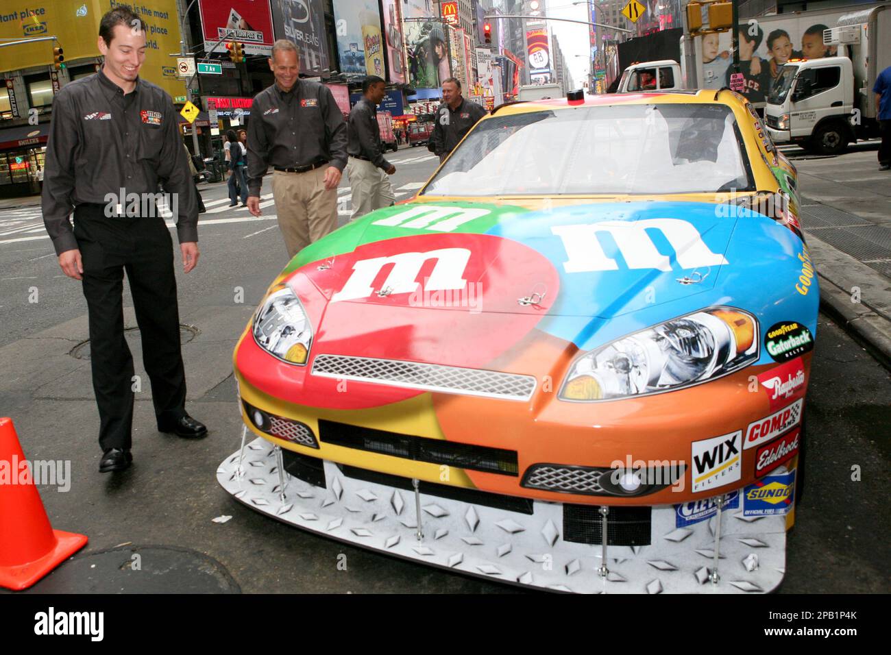 NASCAR driver Kyle Busch, left, checks out the new M&M sponsored NASCAR ...