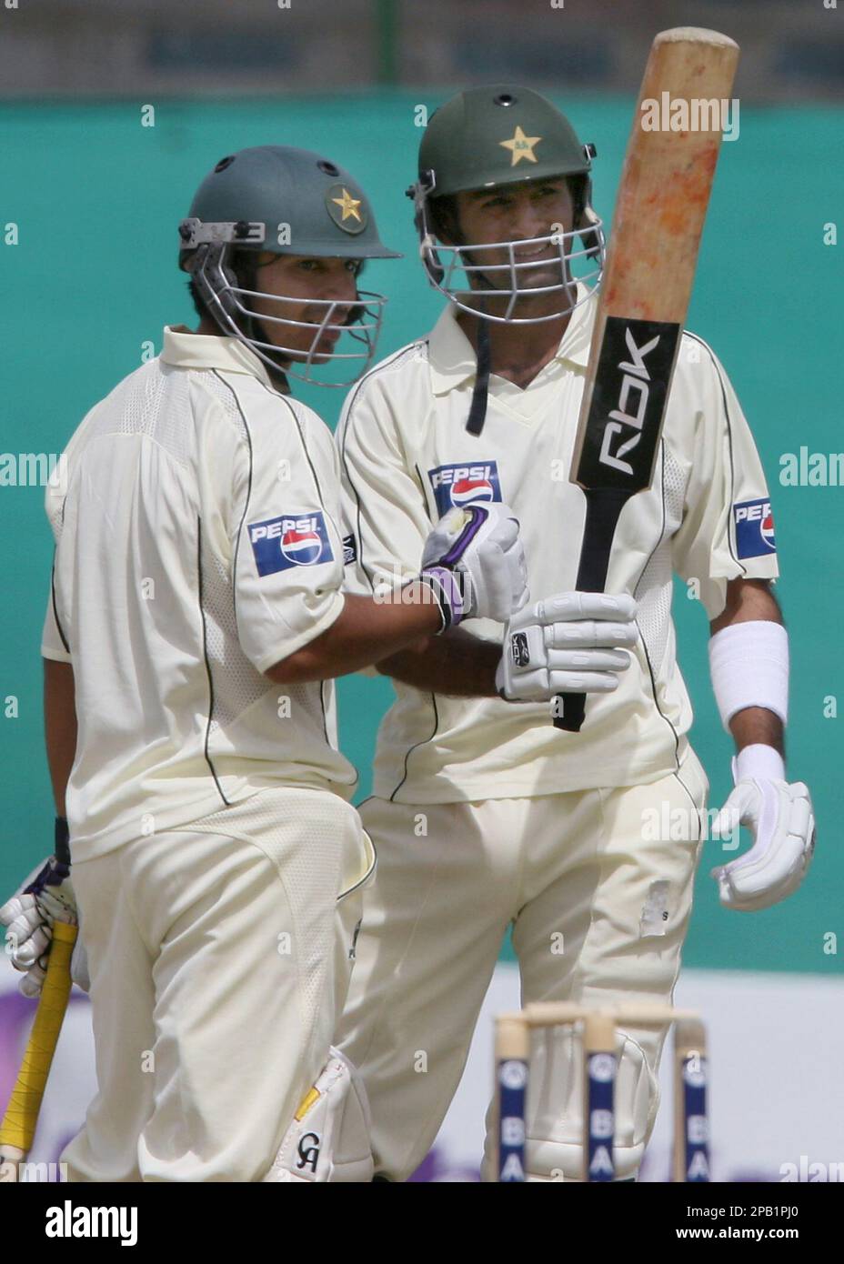 Pakistani batsman Shoaib Malik, left, waves bat to response the crowd ...
