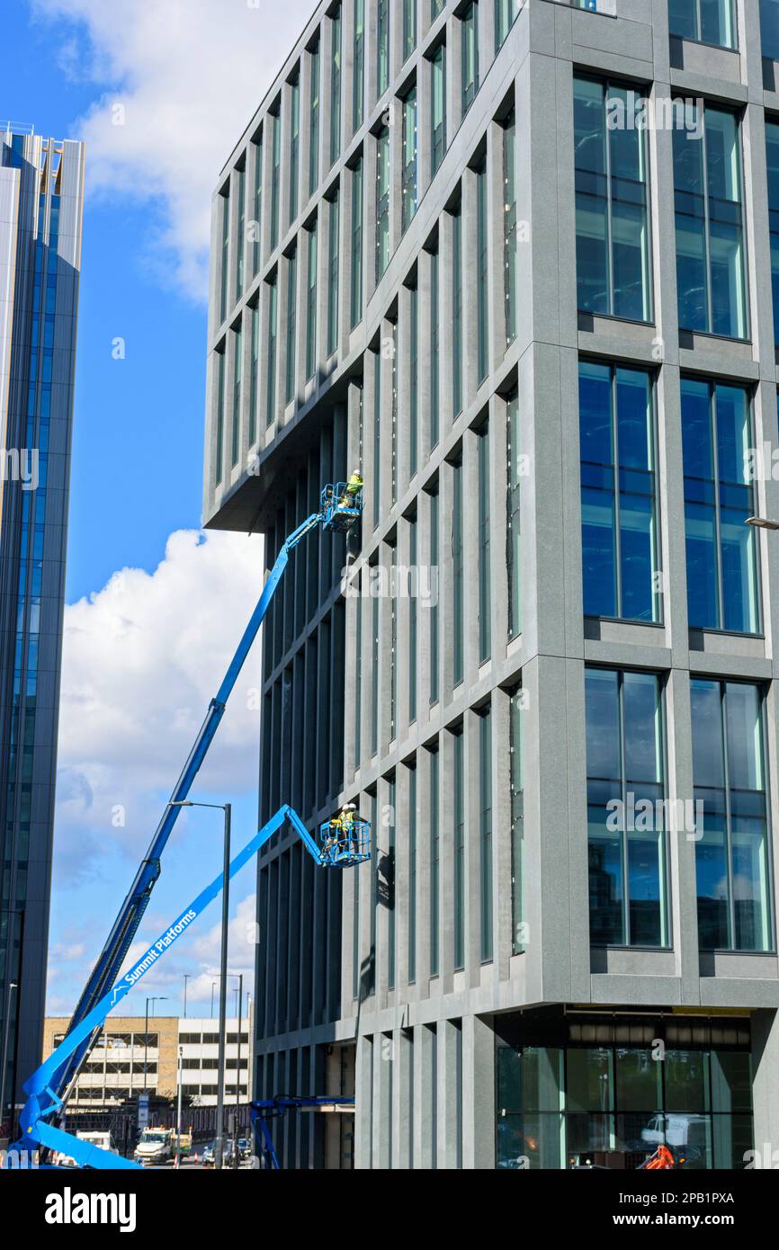 Two 'cherry pickers' working on the number 4 Angel Square office ...