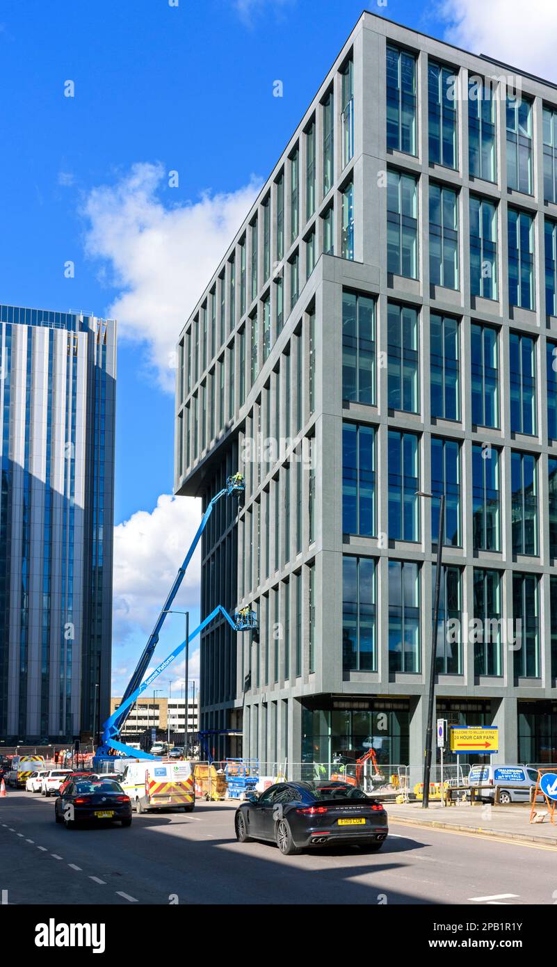 Two 'cherry pickers' working on the number 4 Angel Square office ...