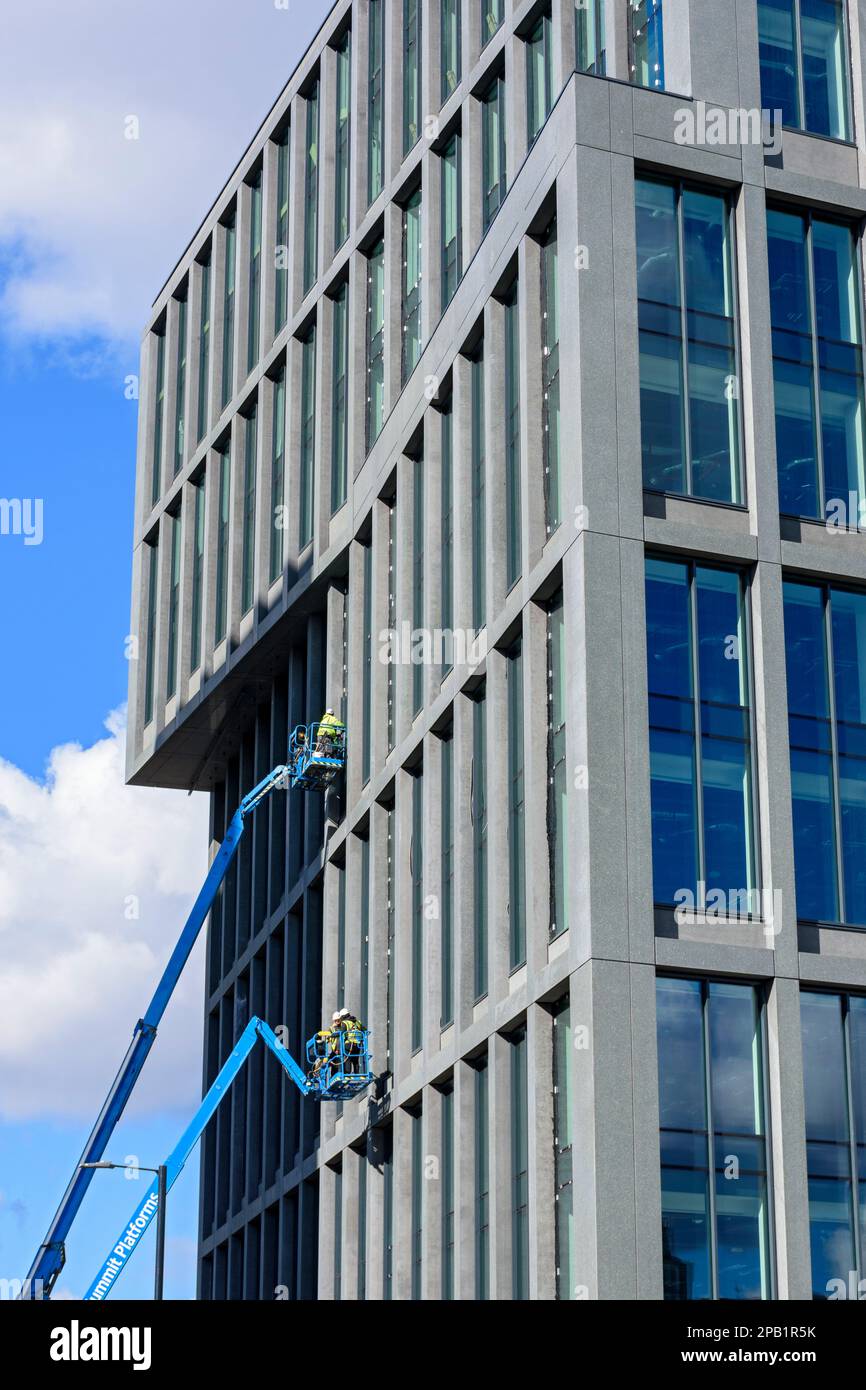 Two 'cherry pickers' working on the number 4 Angel Square office ...
