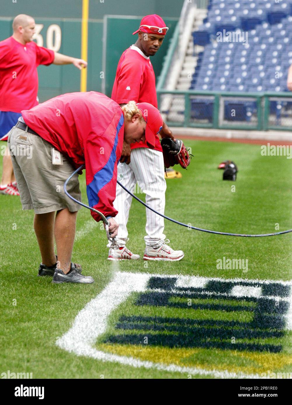 Philadelphia Phillies Jimmy Rollins watches as a logo is painted on the ...