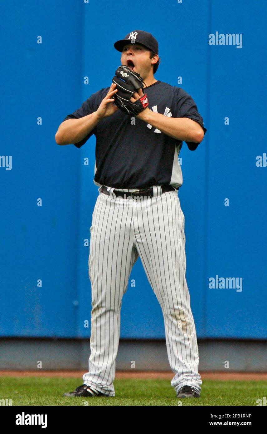 New York Yankees Joba Chamberlain yawns while standing in the outfield ...