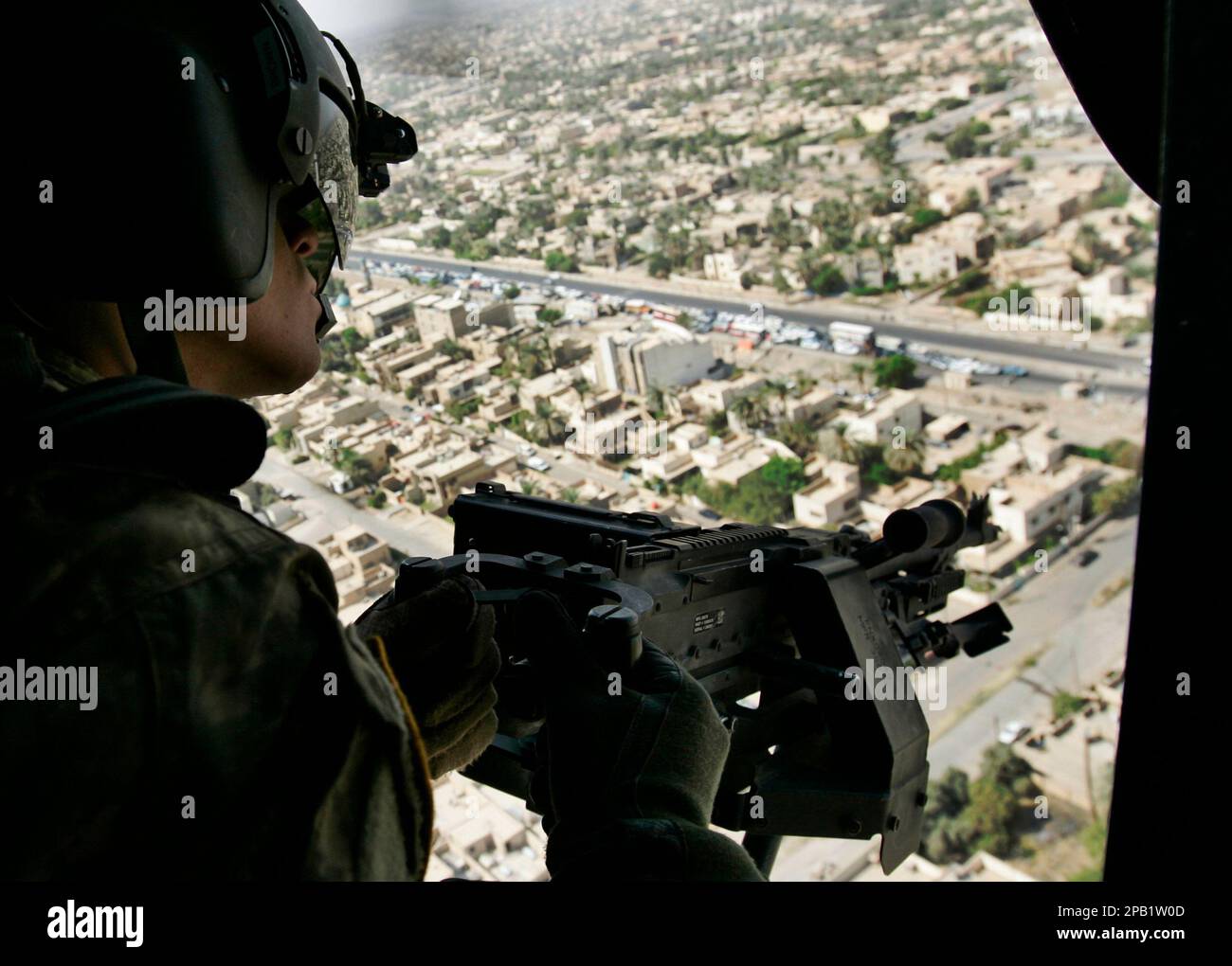 United States Army helicopter gunner Daniel Brown scans the Iraqi ...