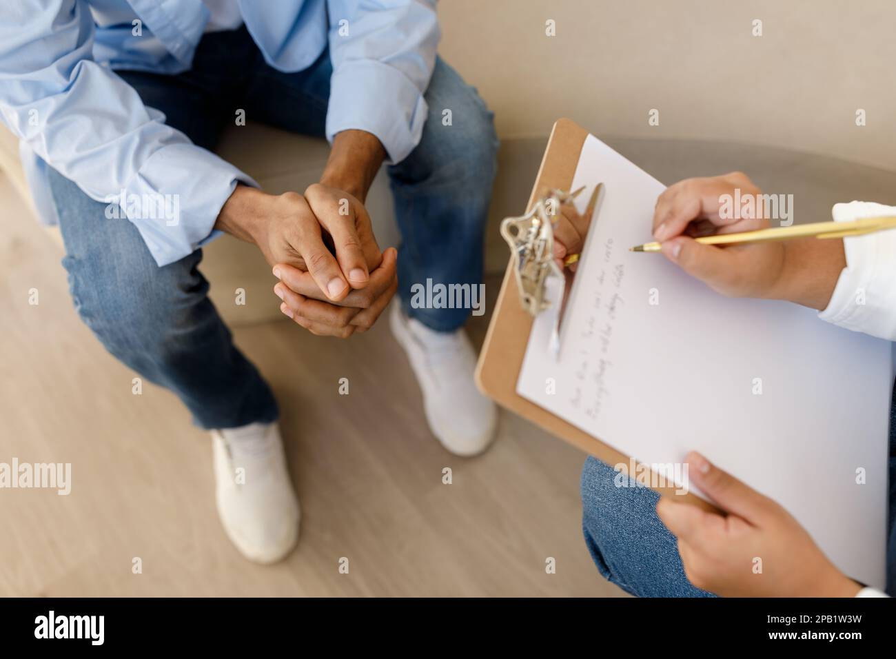 High angle view of therapist taking notes during therapy session Stock ...
