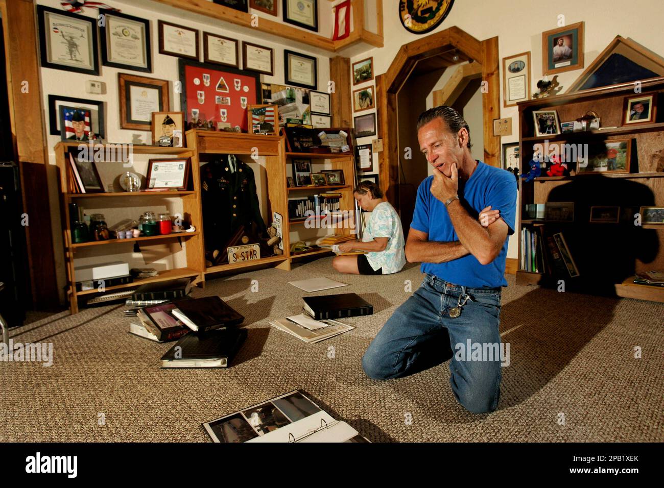 Jim Butler looks over items belonging to his son, Sgt. Jake Butler ...