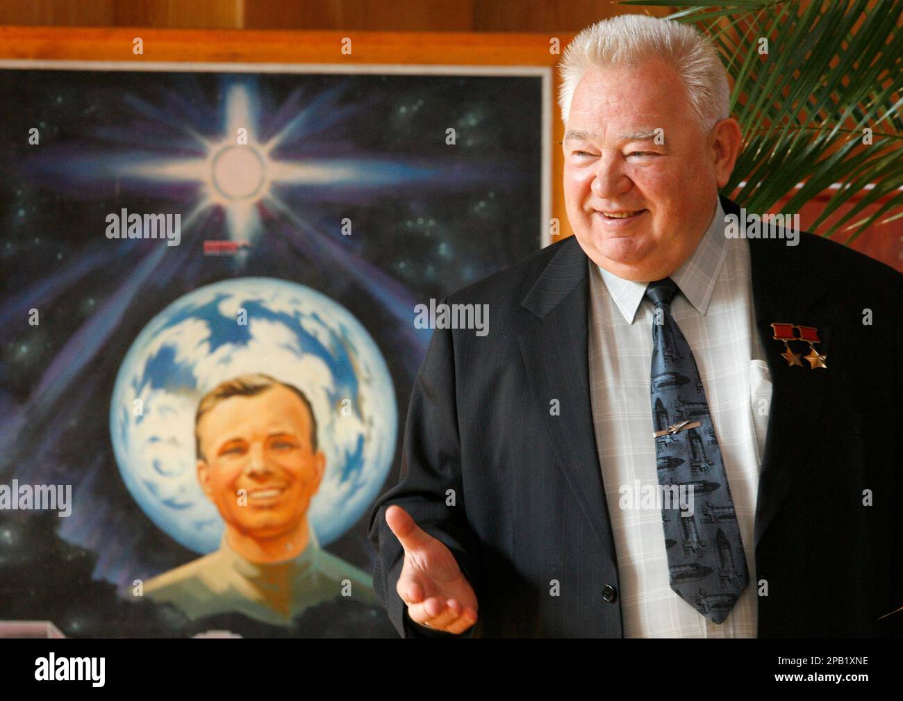 Cosmonaut Georgy Grechko stands in front of a painting showing Yuri ...