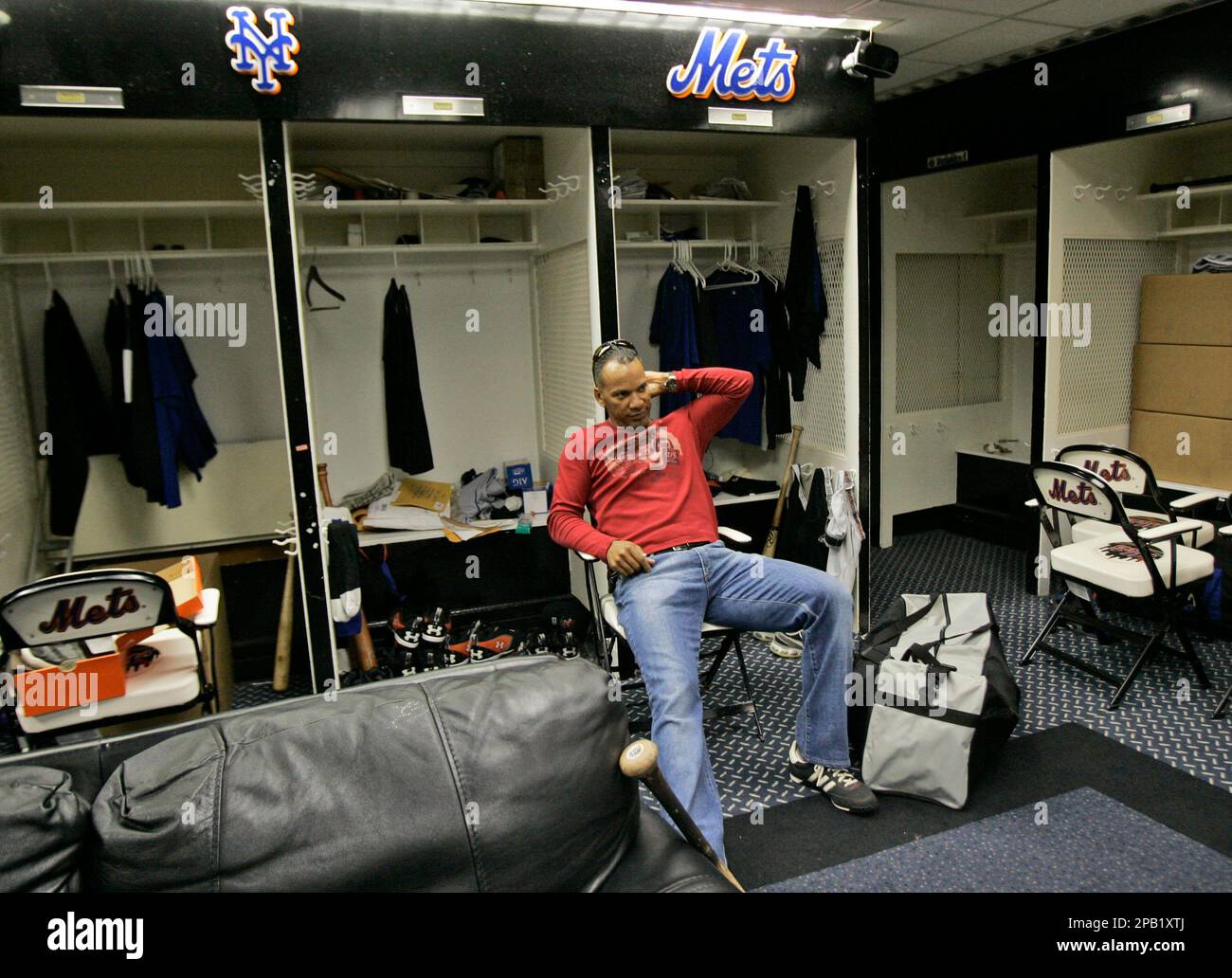 New York Mets' Moises Alou takes a break from packing his belongings in ...
