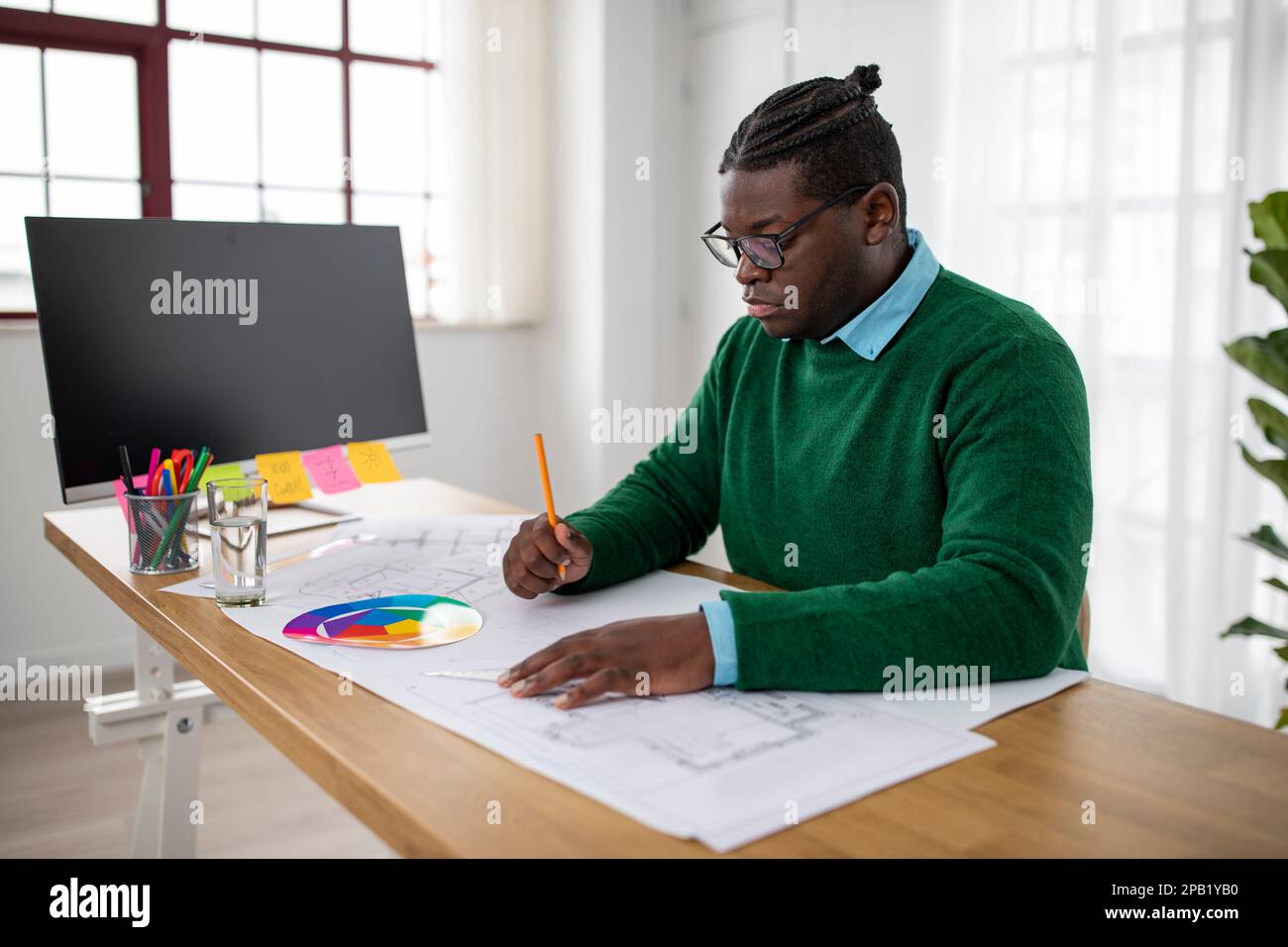 African Male Architect Working On Technical Drawing In Modern Office ...