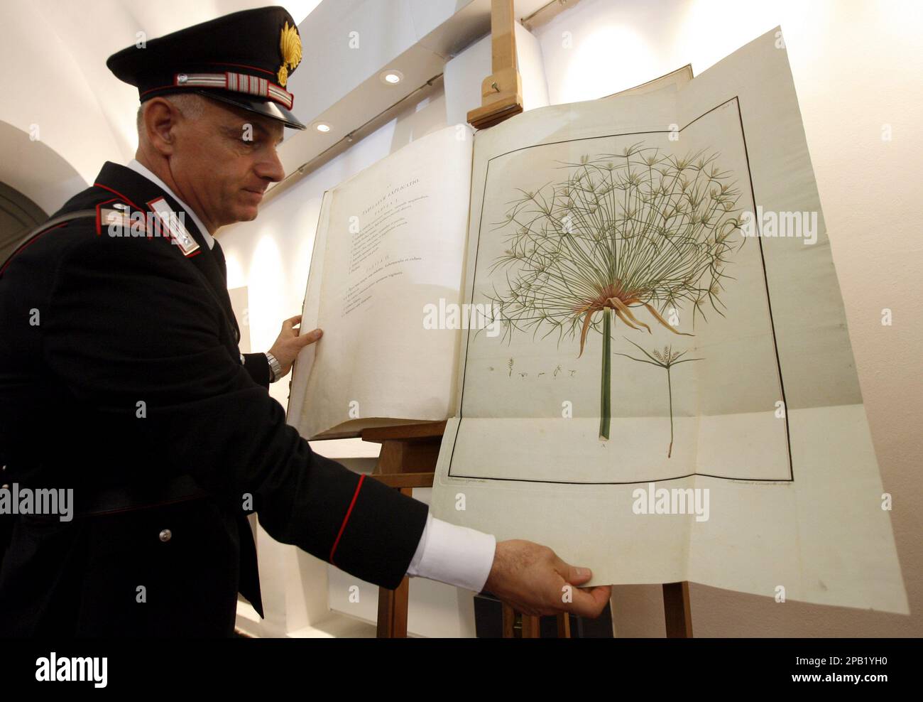 A Carabinieri paramilitary police officer shows a drawing during a news ...