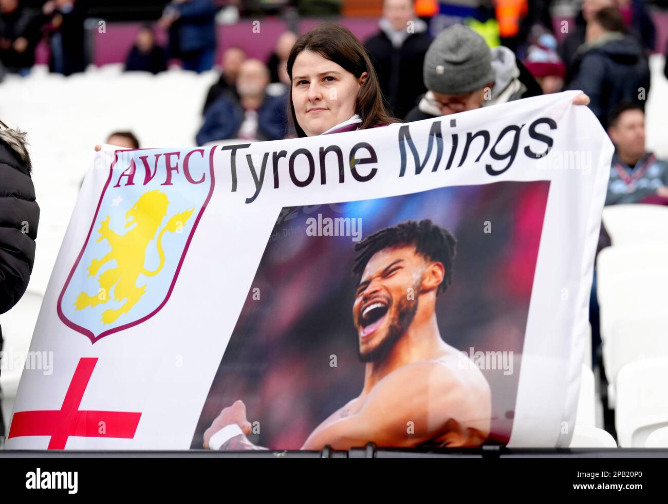 An Aston Villa fan holds up a Tyrone Mings banner ahead of the Premier ...