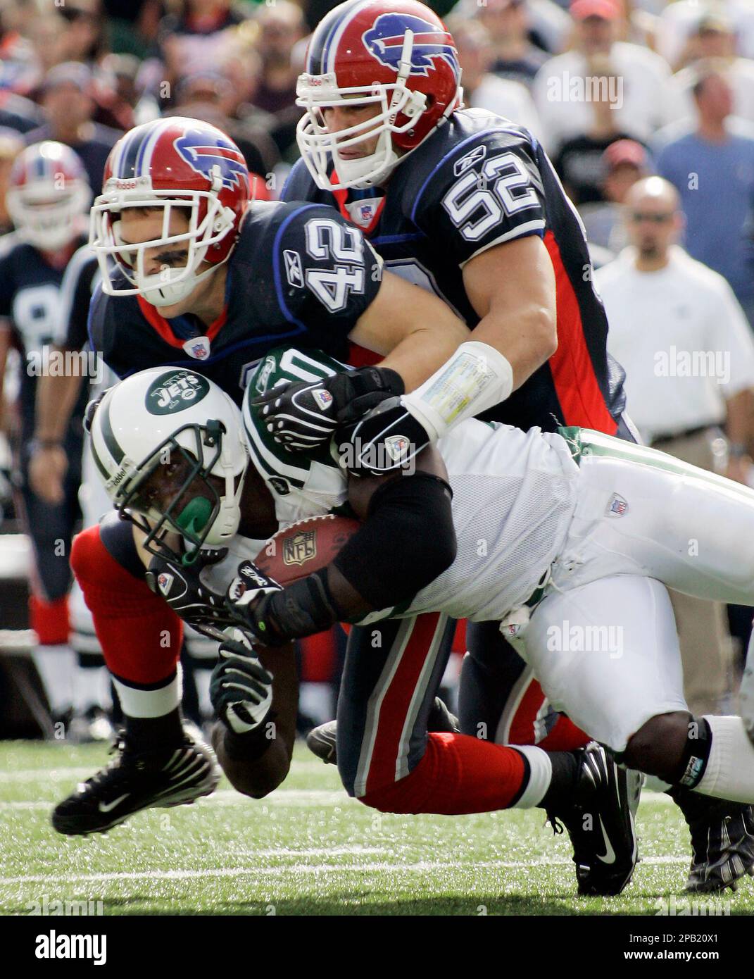New York Jets' Thomas Jones (20) is tackled by Buffalo Bills' Jim ...