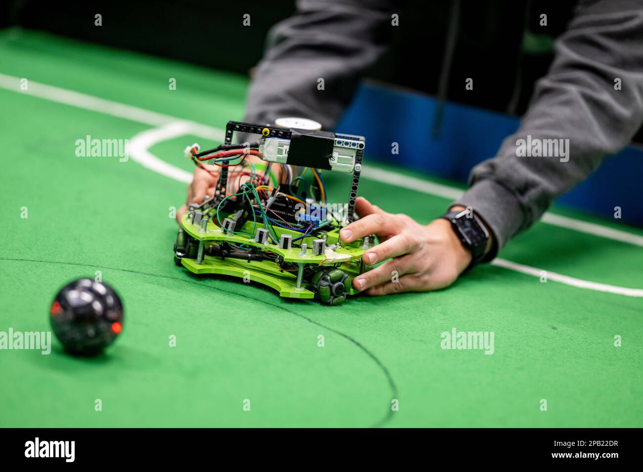 Berlin, Germany. 12th Mar, 2023. A participant puts his robot on the ...