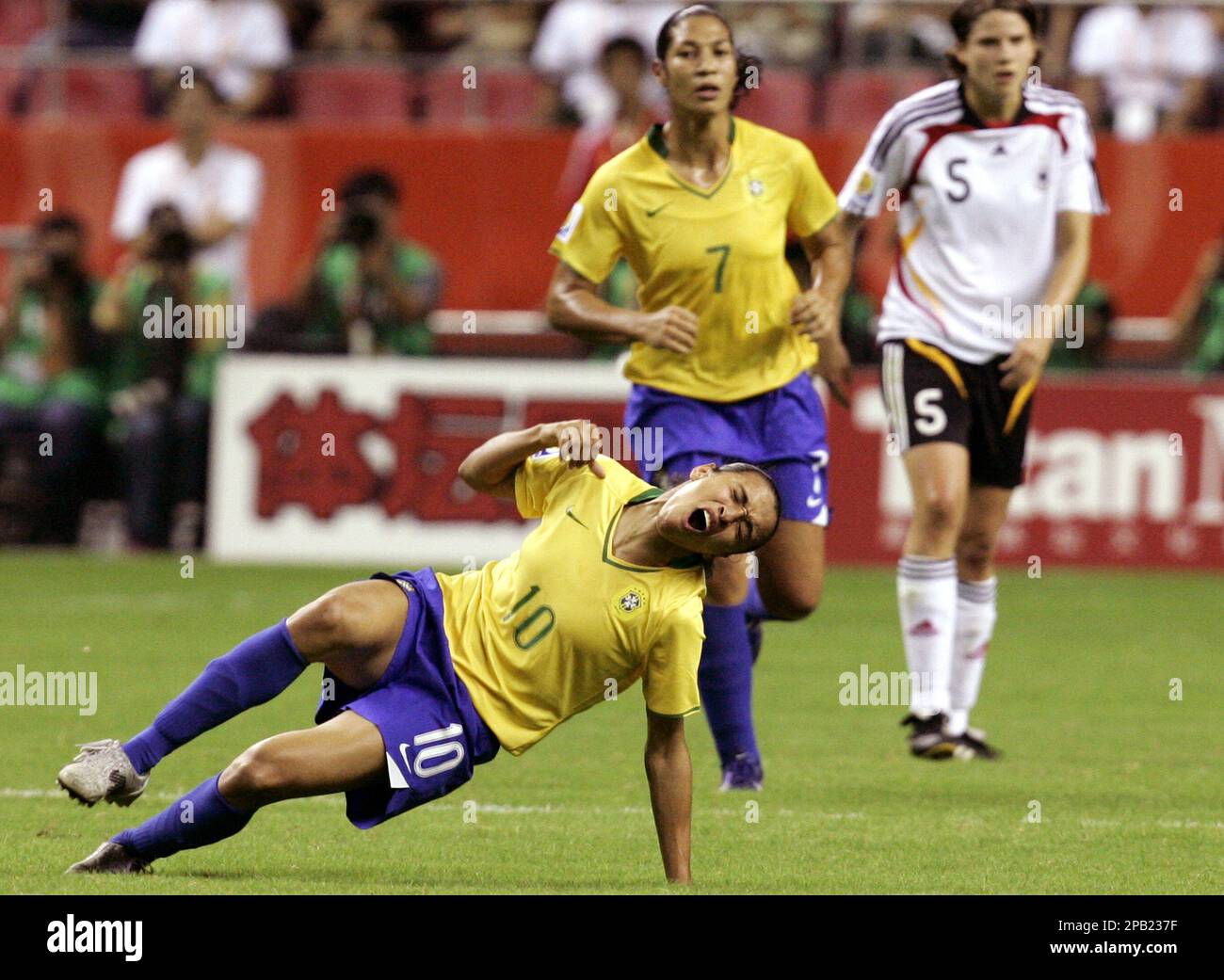 Brazil's forward Marta grimaces after colliding with a German player ...