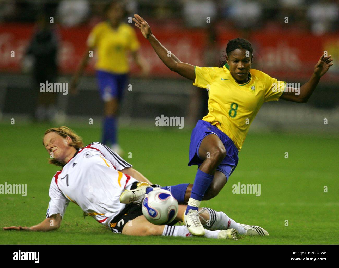 Brazil's Formiga goes down as she is tackled by Germany's Melanie ...