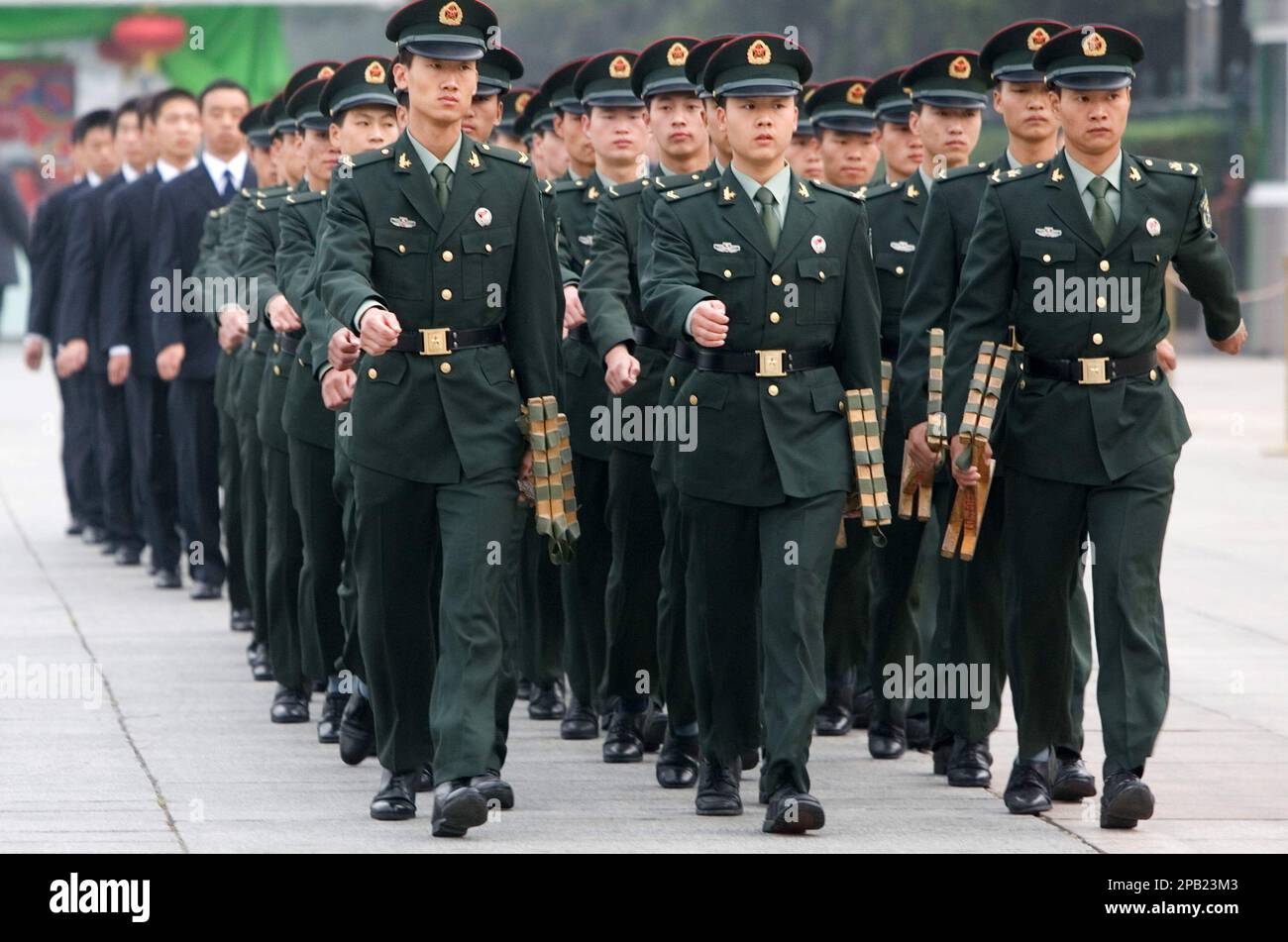 Chinese security personnel march in front of the Great Hall of the ...