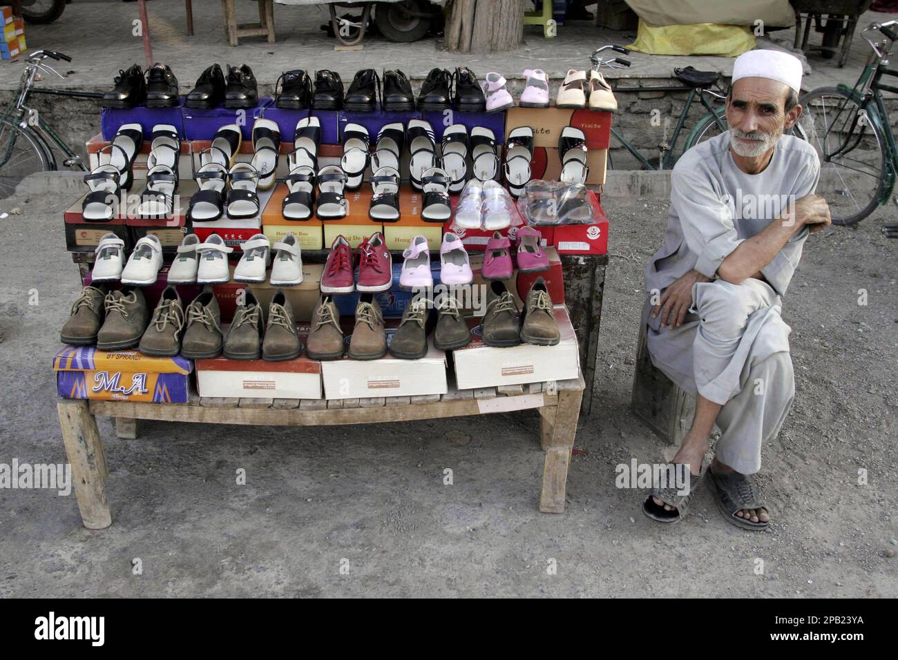 An Afghan street vendor waits for customers in the city of Herat, west ...