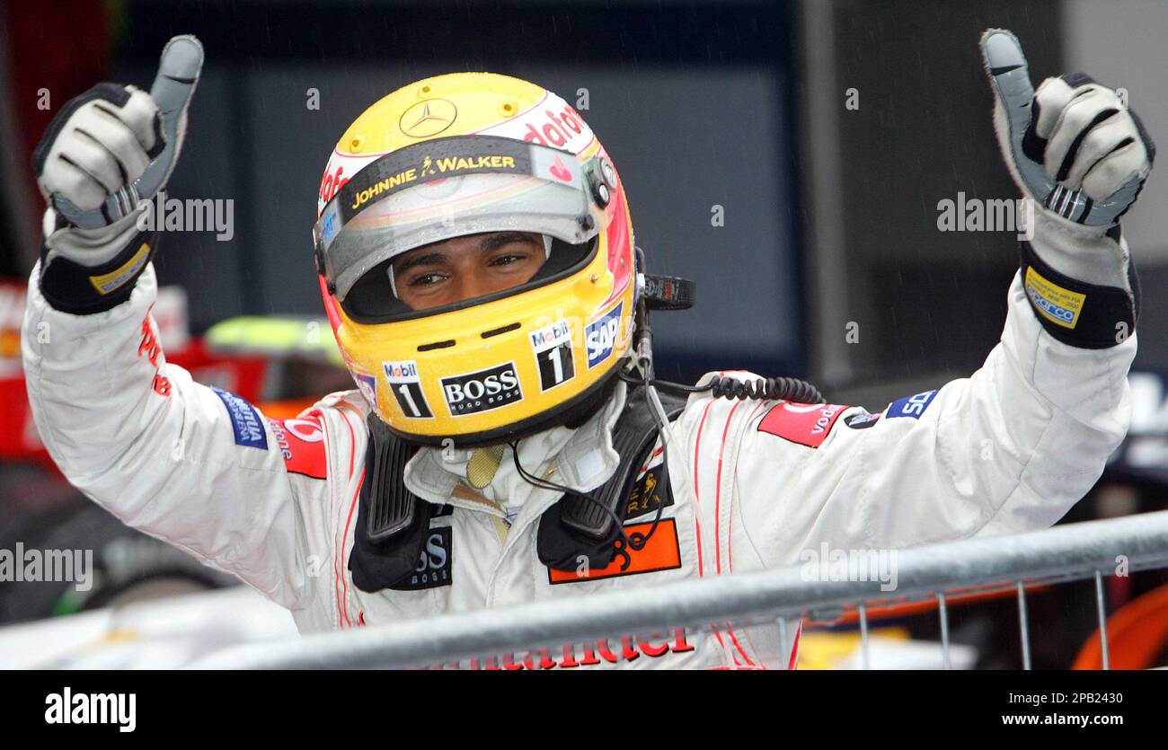 British McLaren-Mercedes driver Lewis Hamilton shows thumbs-up signs ...