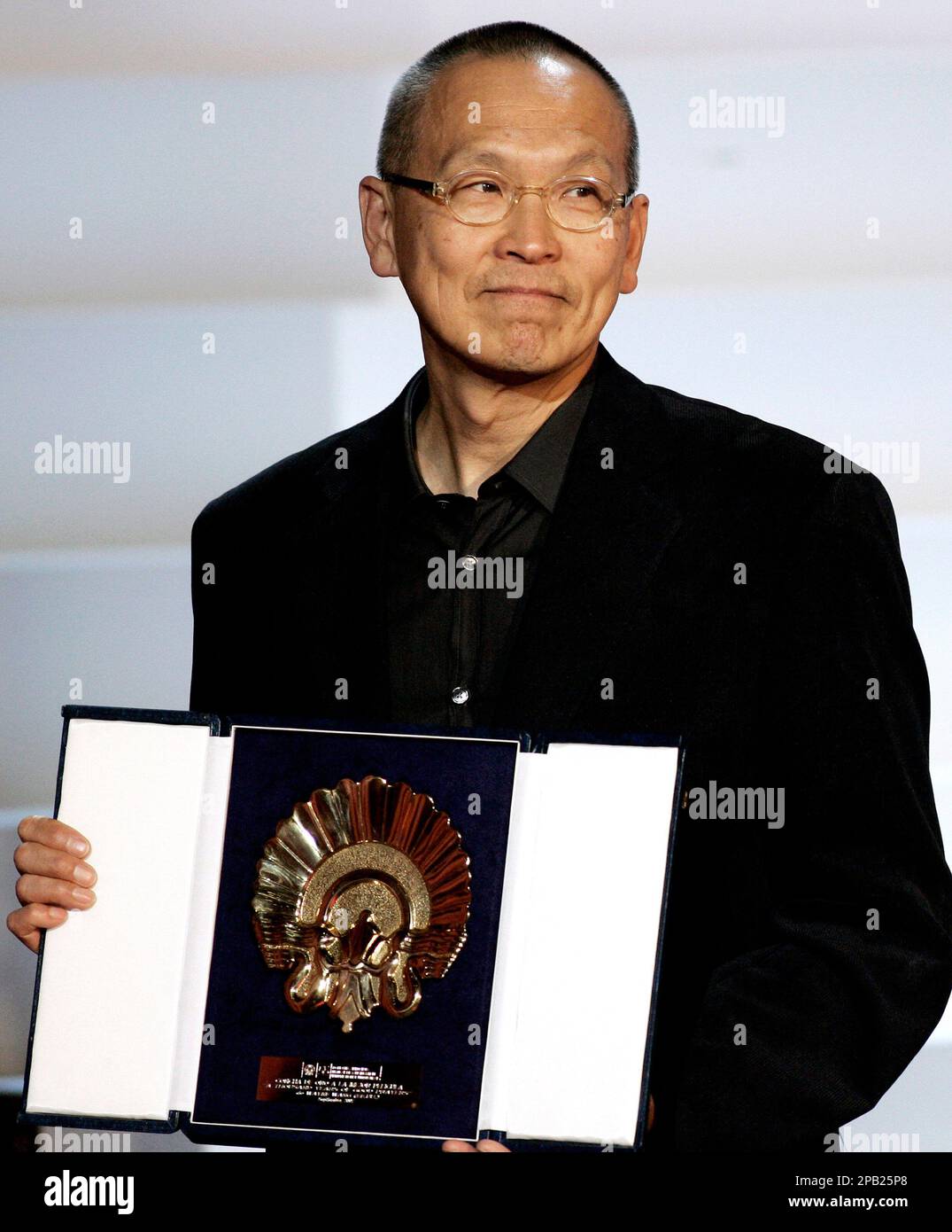 Hong Kong film director Wayne Wang poses after winning the 'Golden ...