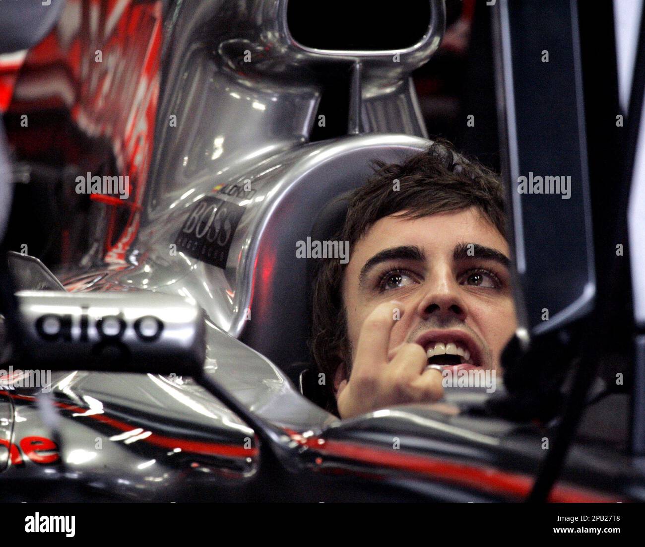 Spain's Fernando Alonso relaxes in the cockpit of his McLaren-Mercedes ...