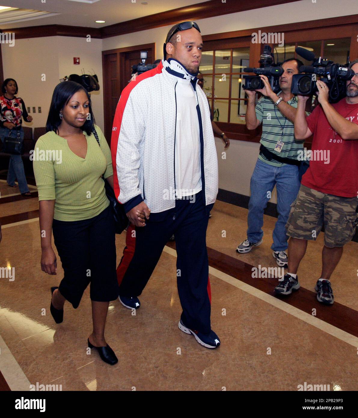 Houston Texans defensive tackle Cedric Killings, right, leaves with his ...