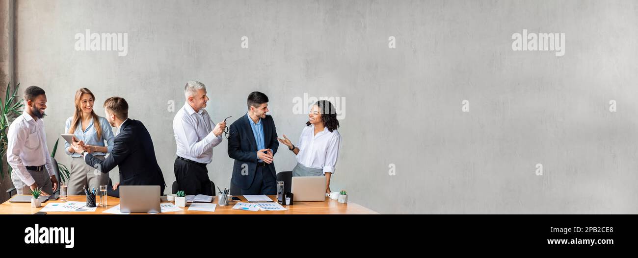 Coworkers Communicating Standing During Business Meeting In Modern ...