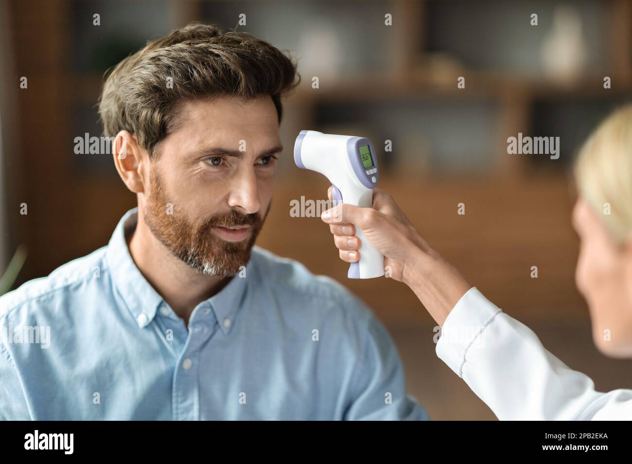 Doctor Lady Checking Body Temperature For Male Patient With Infrared ...