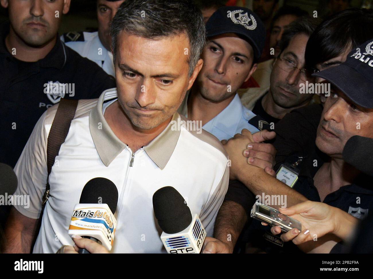 Portuguese soccer coach Jose Mourinho is escorted by police officers on ...