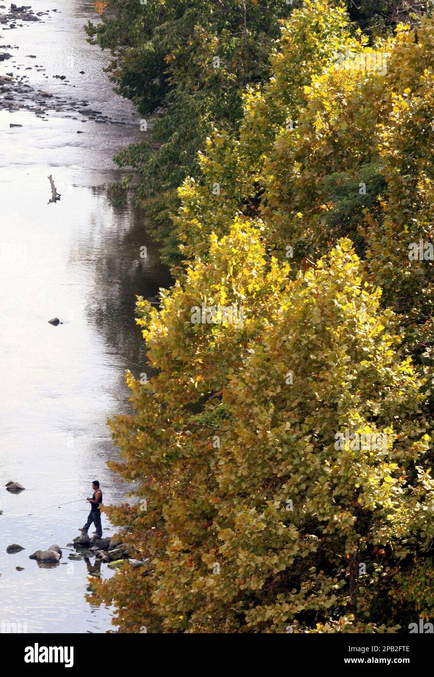 A fisherman casts his line into the Scioto River below the O ...