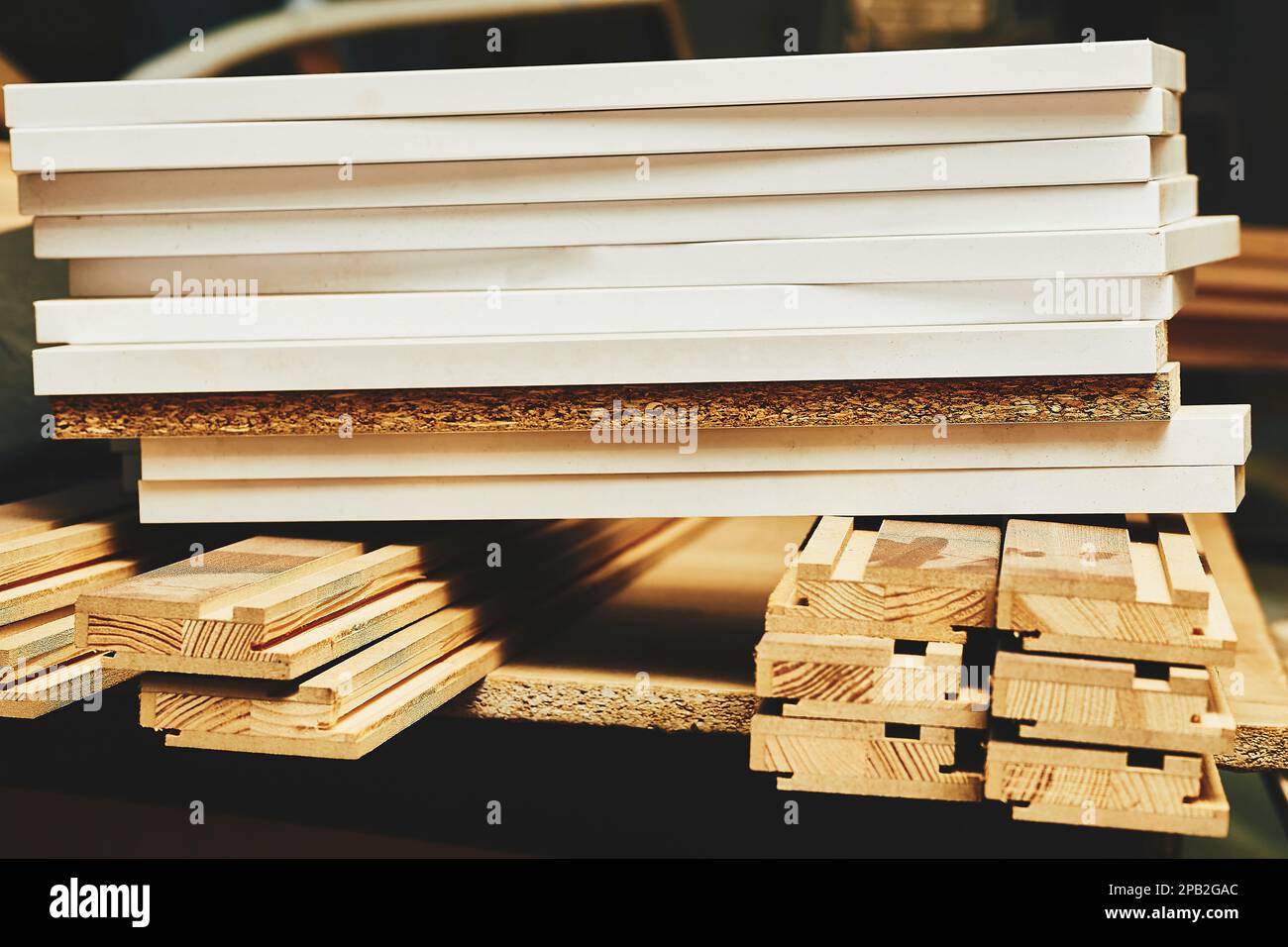 Sheets of plywood, boards, lumber stacked in rows in a carpentry in a ...