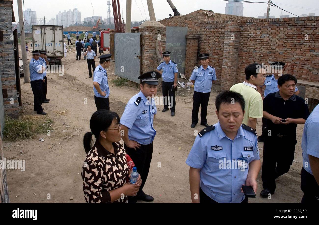 Chinese police officers on duty at a squatter village used by ...