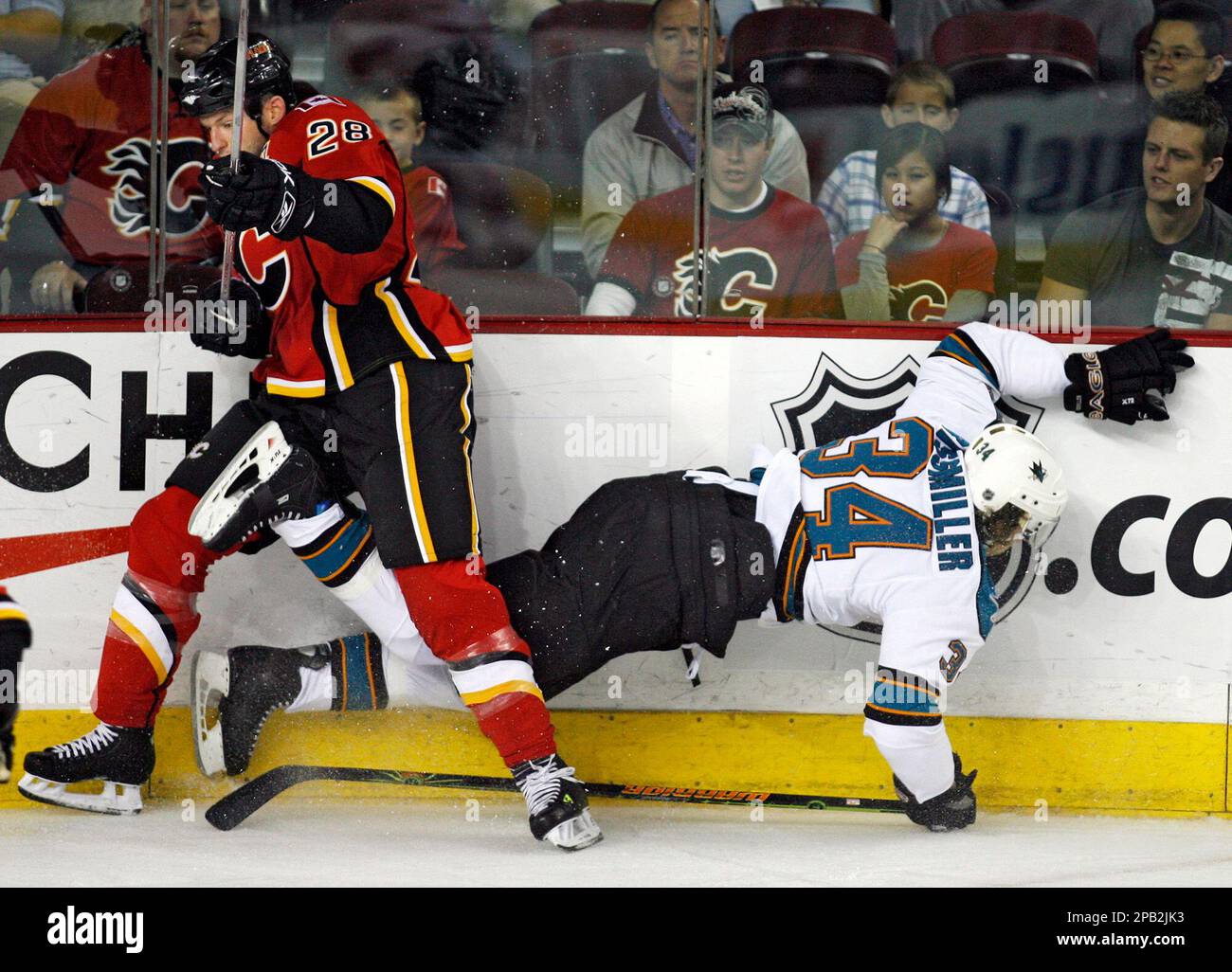 San Jose Sharks' Patrick Rissmiller, right, gets slammed into the ...