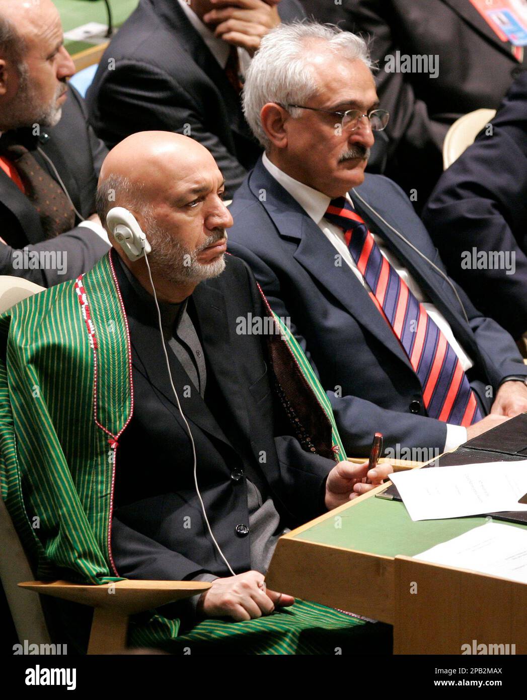 Afghanistan President Hamid Karzai, left, sits with members of his ...
