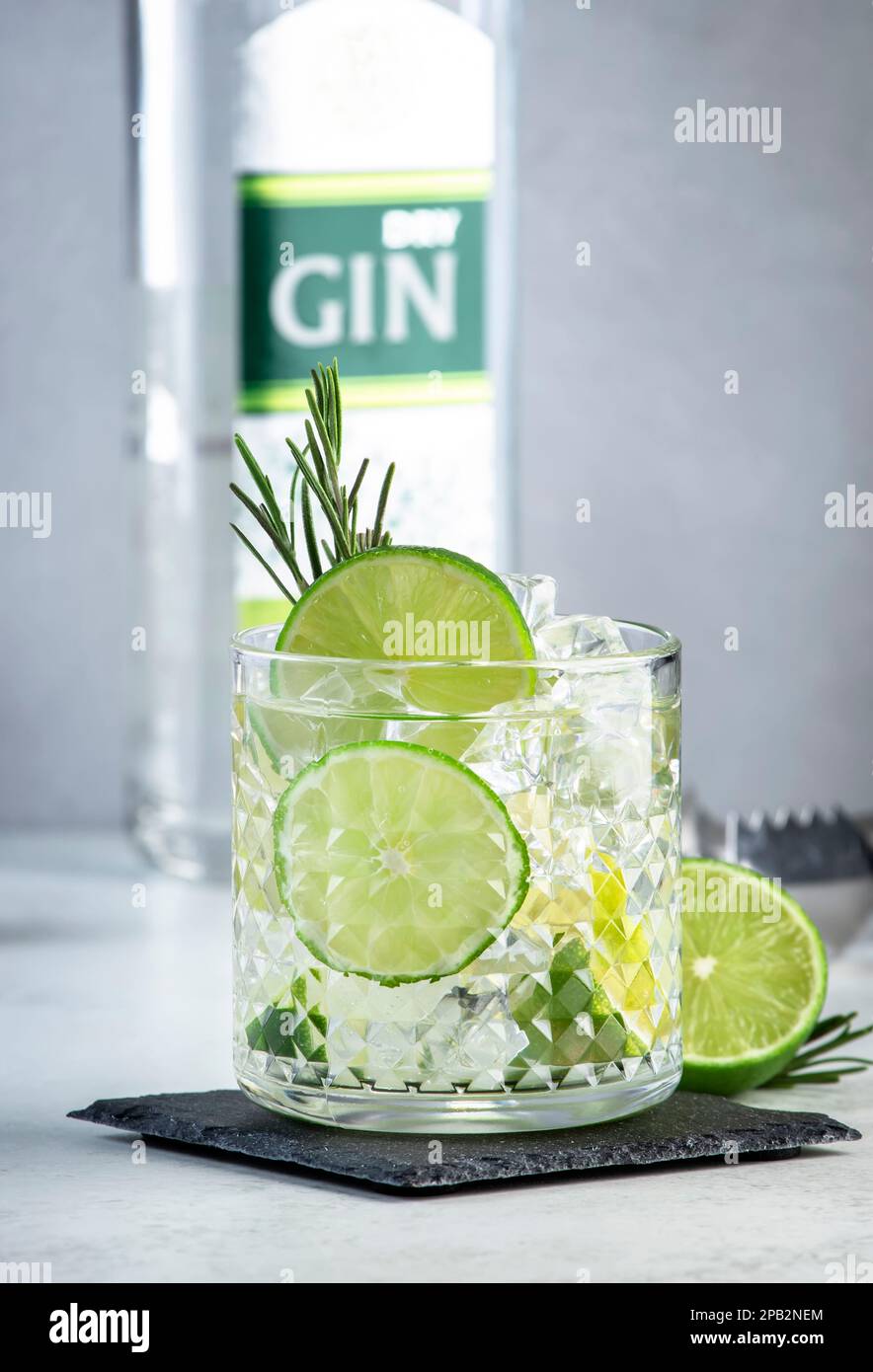 Gin tonic classic cocktail drink with dry gin, bitter tonic, lime and ...
