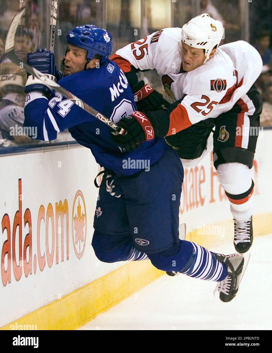 Ottawa Senators forward Chris Neil. right, drives Toronto Maple Leafs ...
