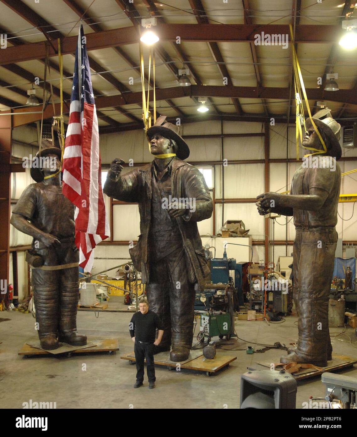 Sculptor Stan Watts stands in front of his three-times lifesize, bronze ...