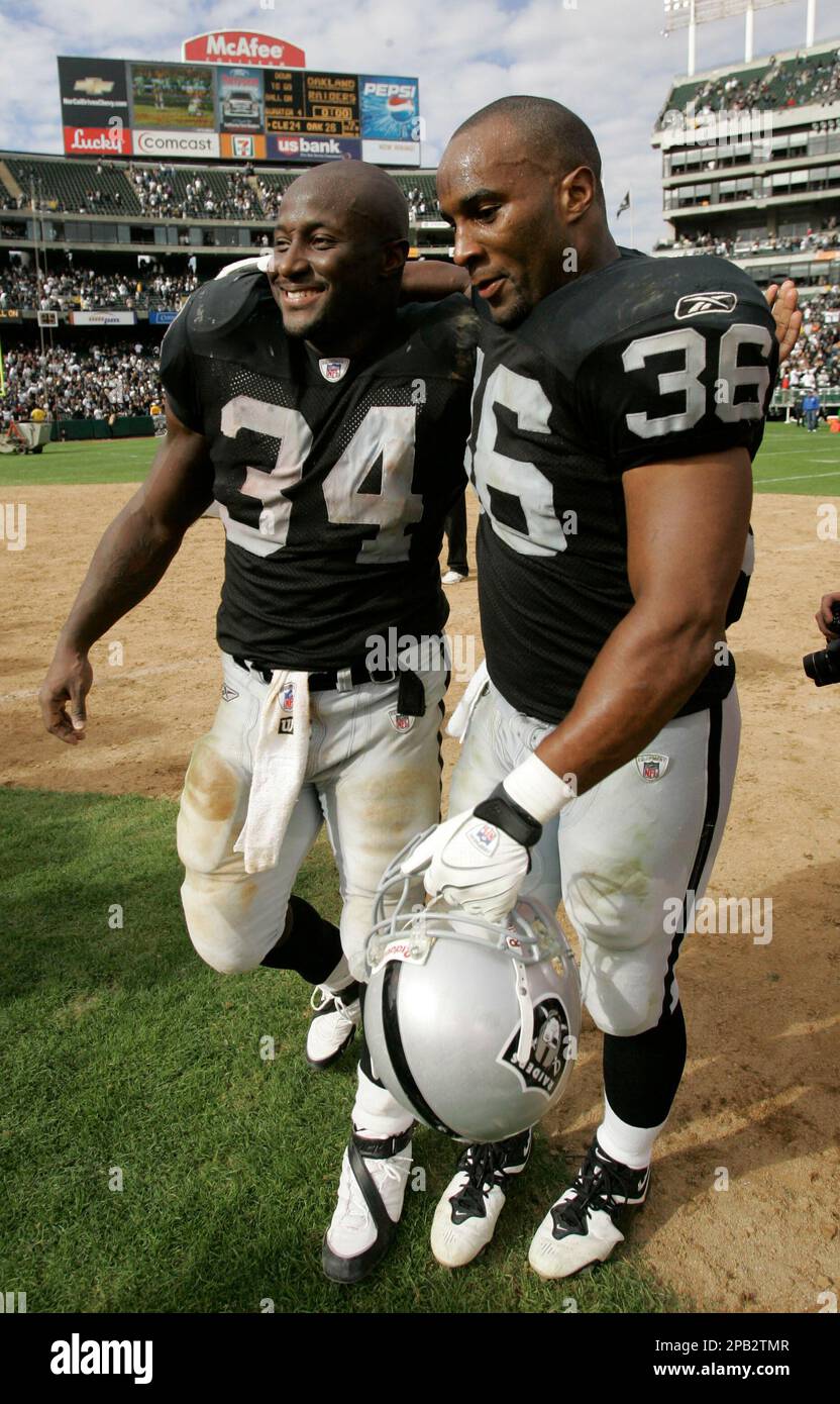 Oakland Raiders running back LaMont Jordan, left, and teammate Justin ...