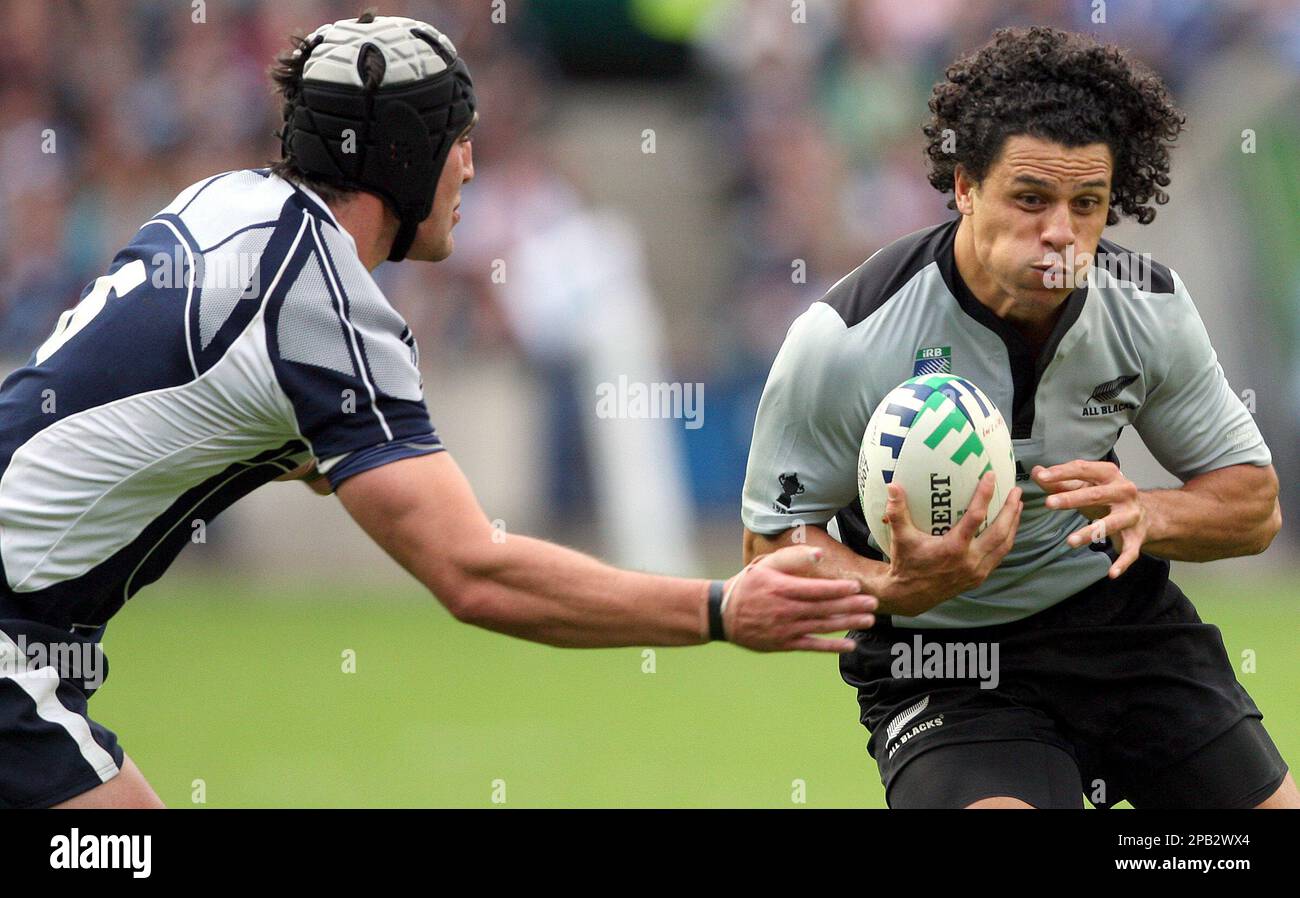 Doug Howlett of New Zealand is tackled by Scotland's Kelly Brown, left ...