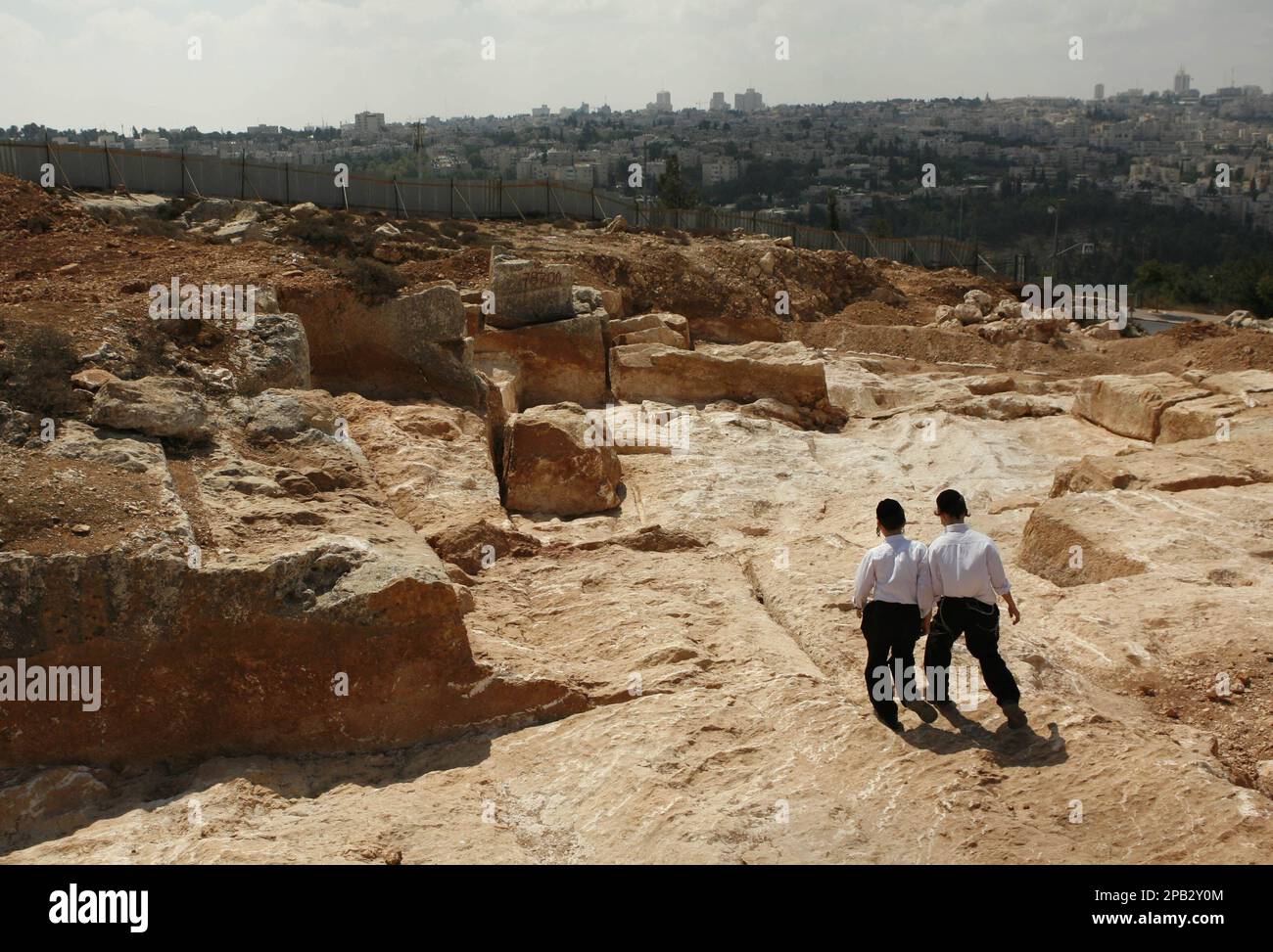 Ultra-Orthodox Jewish youths walk through an ancient quarry at an ...