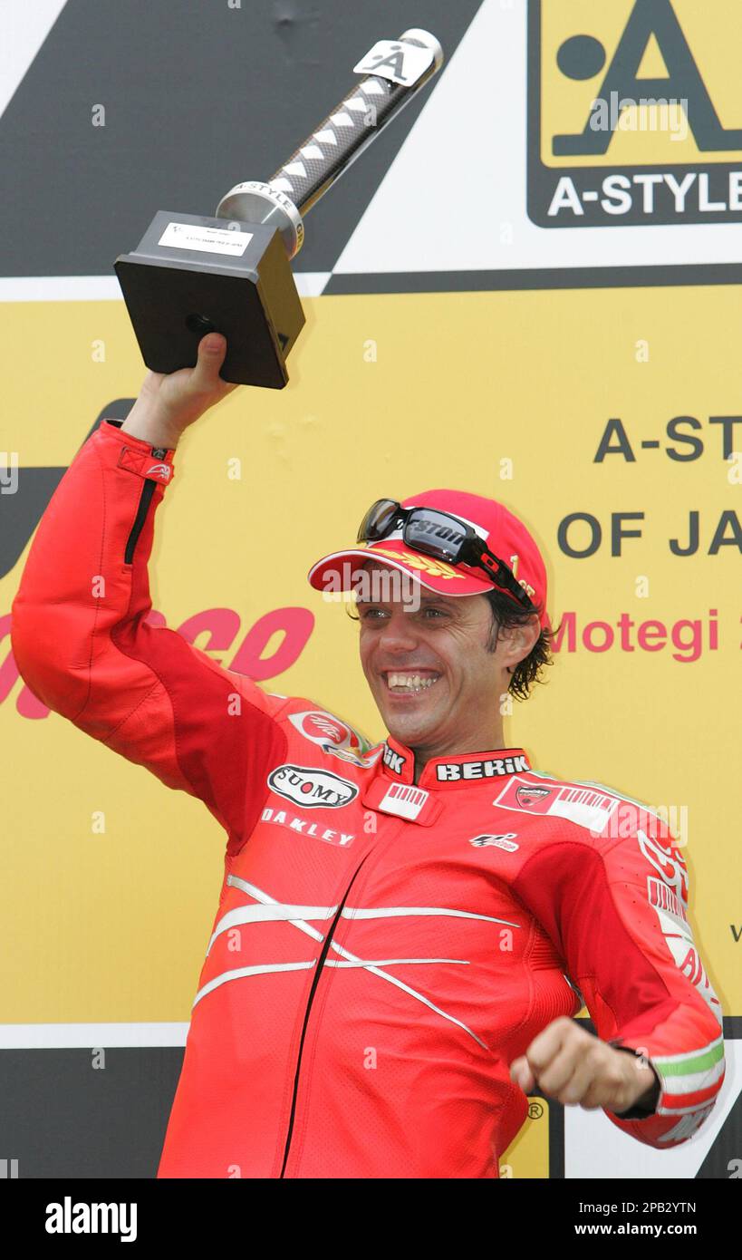 Ducati MotoGP rider Loris Capirossi of Italy raises his trophy on the ...