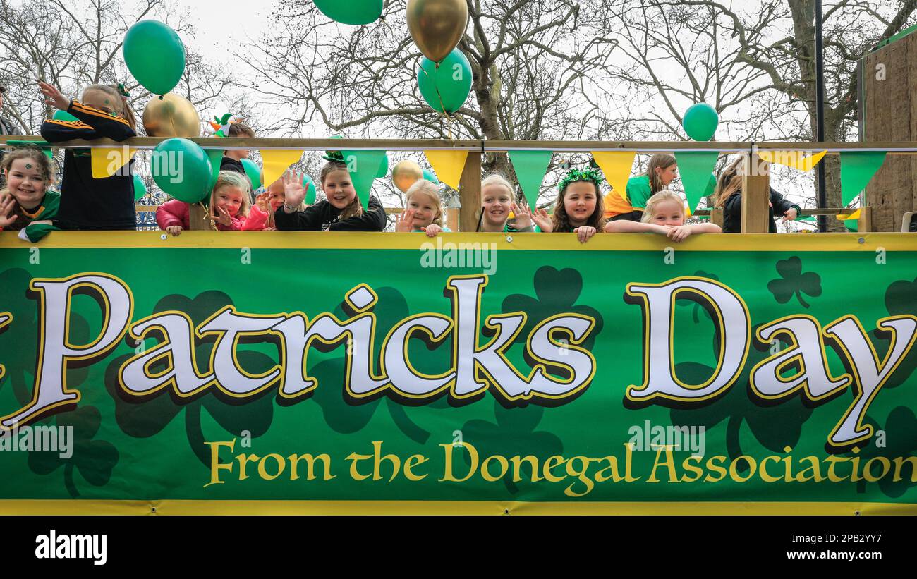 London, UK. 12th Mar, 2023. A group of Irish children wave from the ...