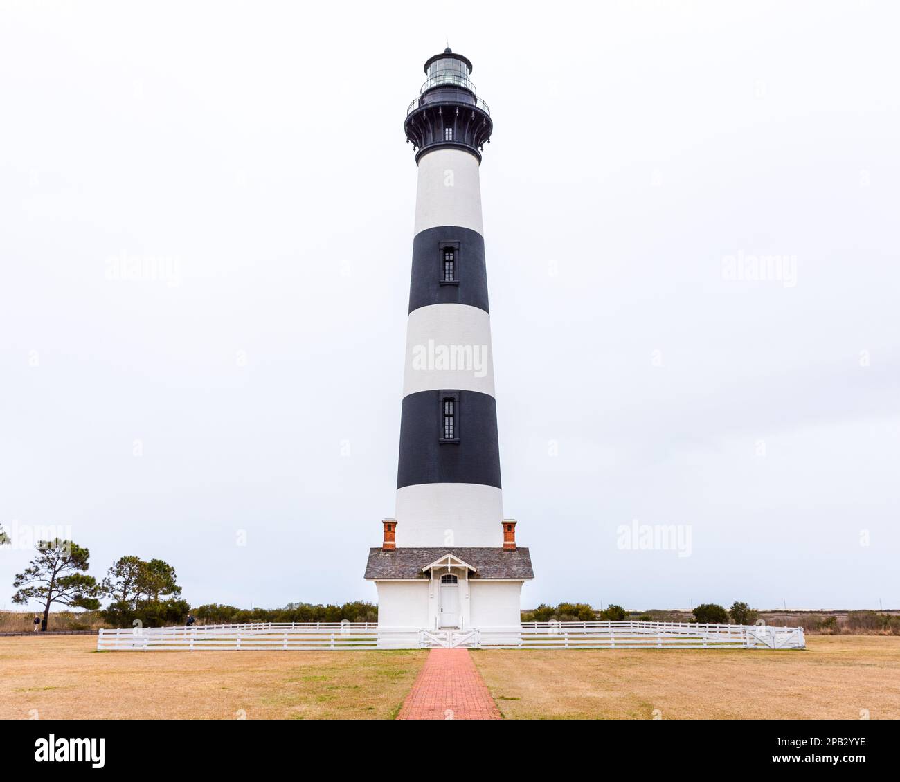 Bodie Island Lighthouse with light keeper's house, surrounded by white ...